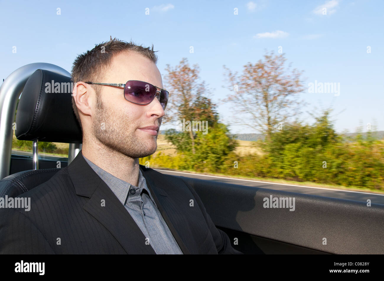 Successful businessman in a convertible Stock Photo - Alamy