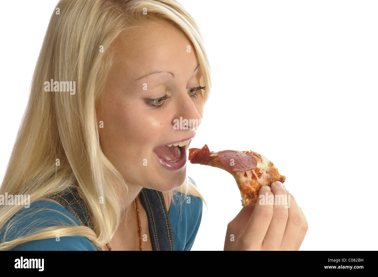 Woman eating a pizza slice Stock Photo - Alamy