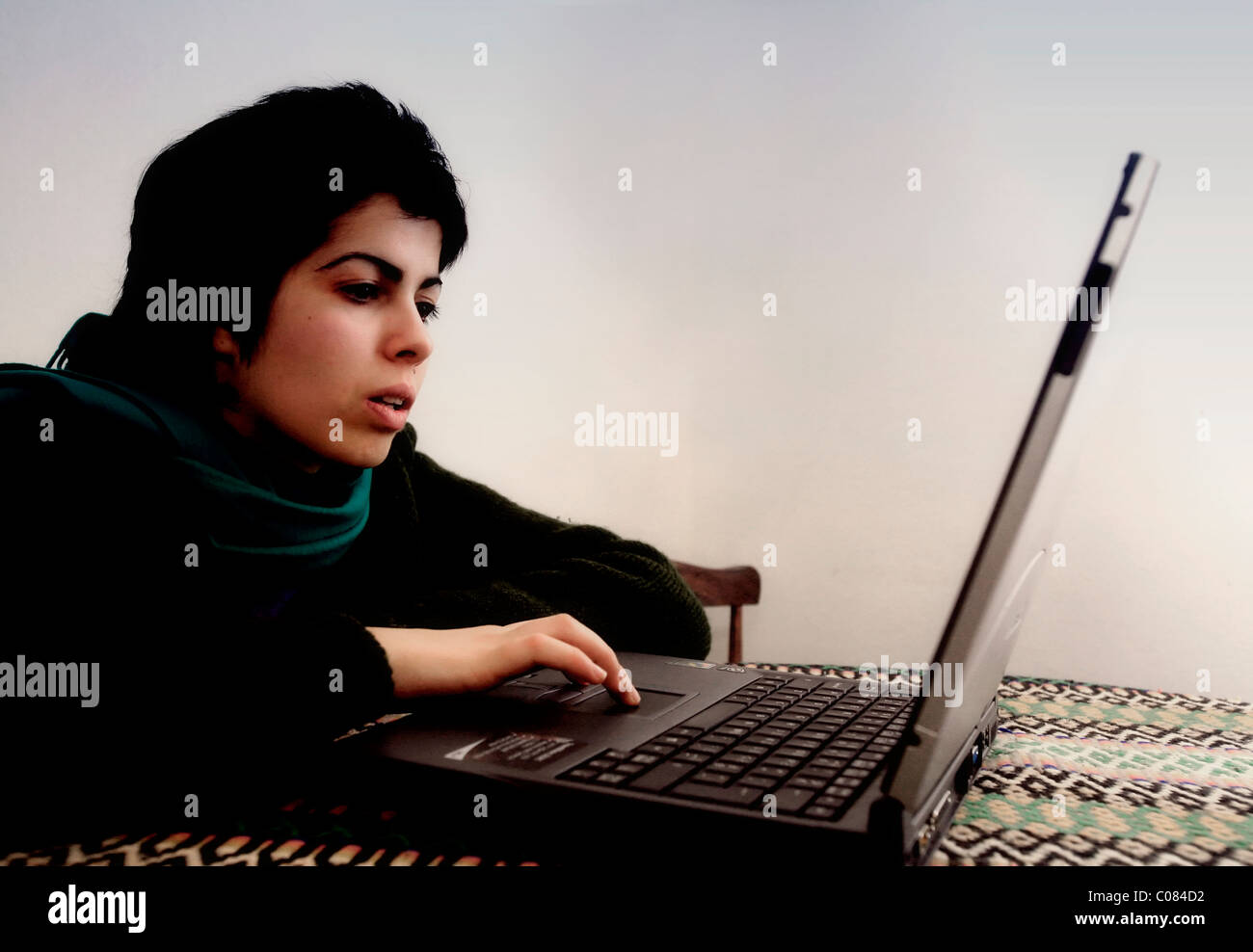 Latin girl typing in a laptop Stock Photo - Alamy