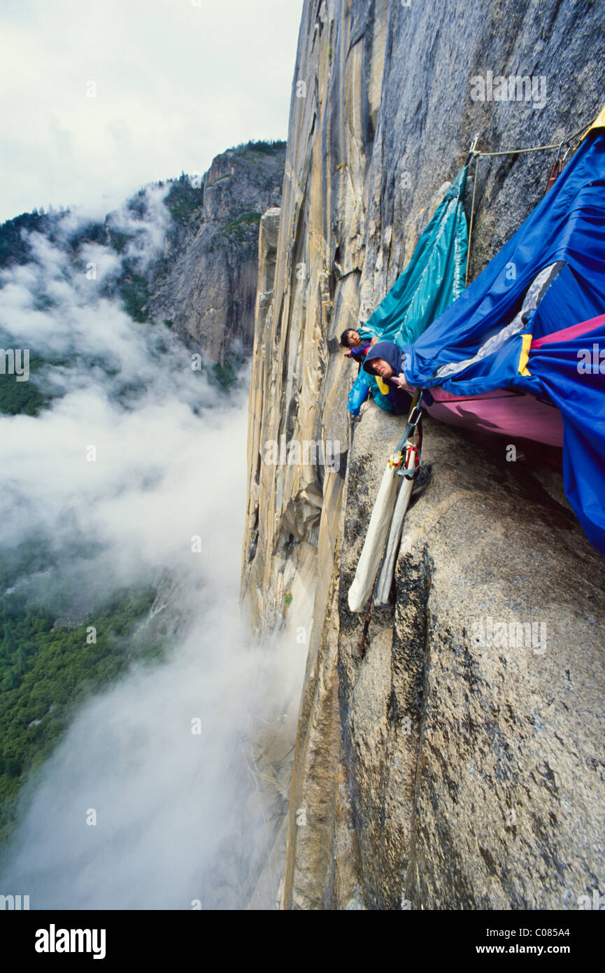 Team of climbers reaching the summit Stock Photo - Alamy