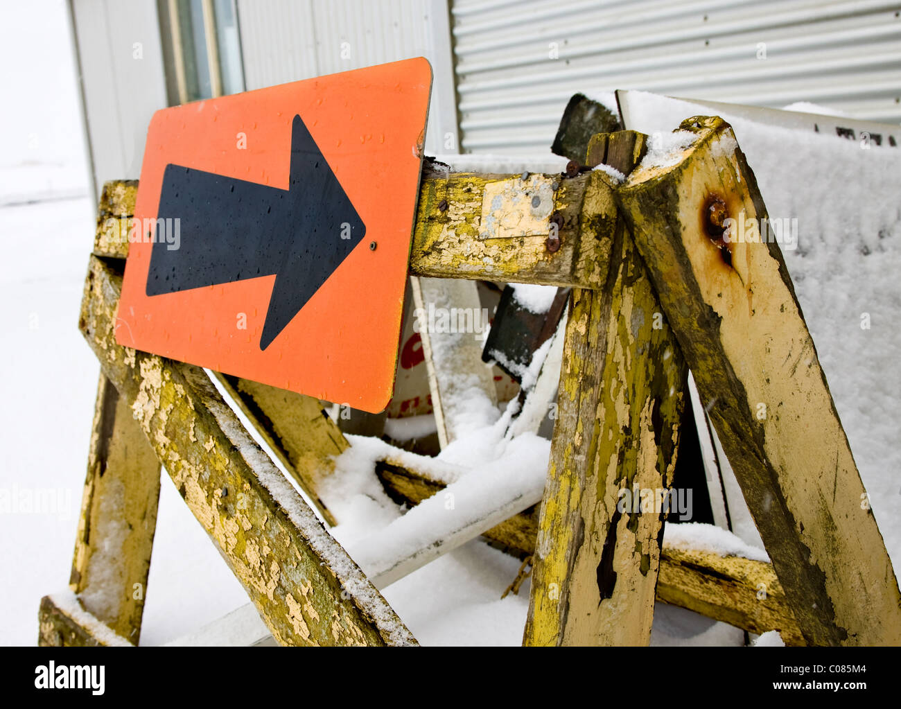 Arrow - road sign out of street in winter time Stock Photo - Alamy