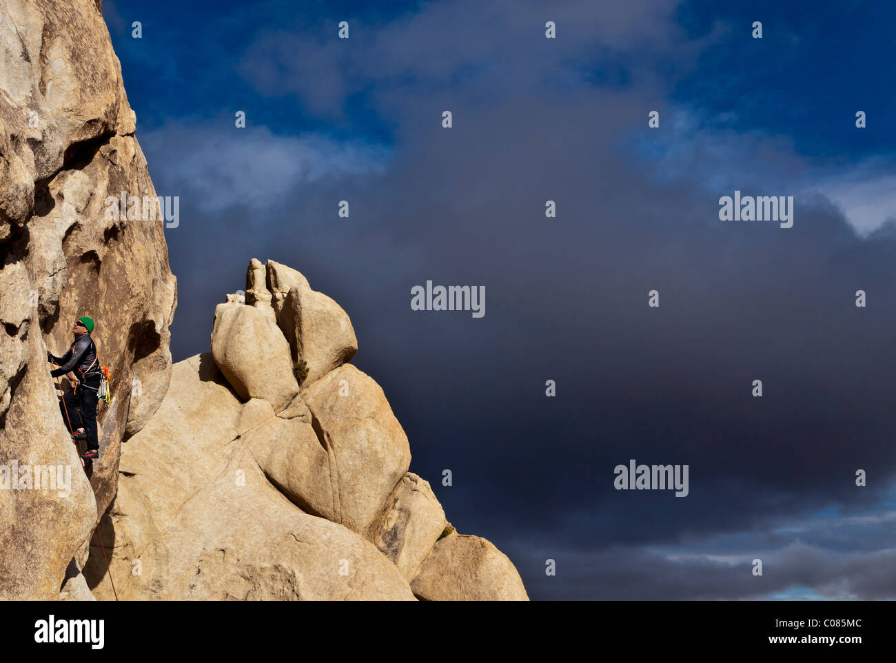 Rock climber struggles for his next grip on a overhanging cliff Stock ...