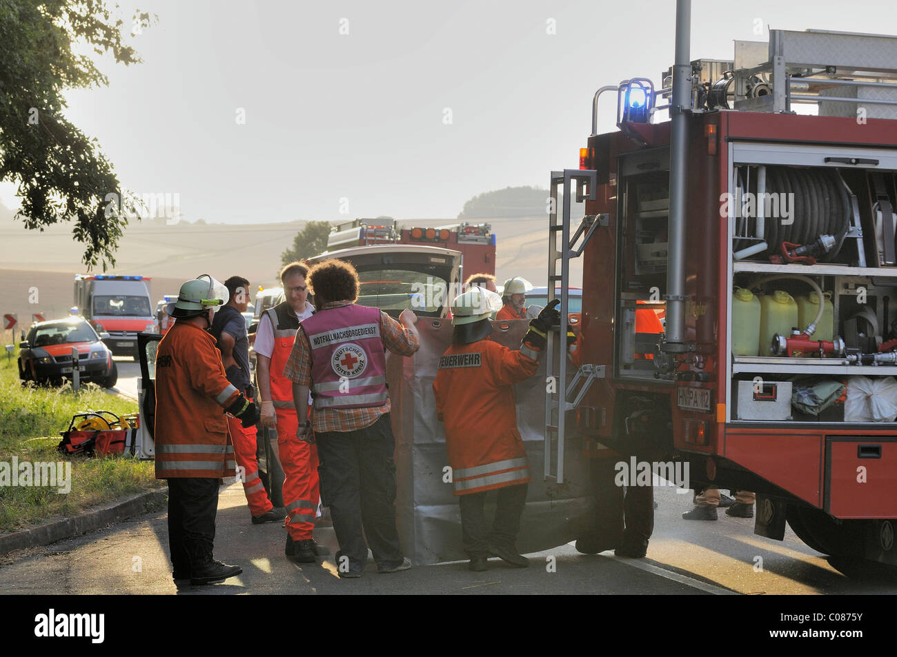 Officers keep up screens up during the recovery of bodies after a ...