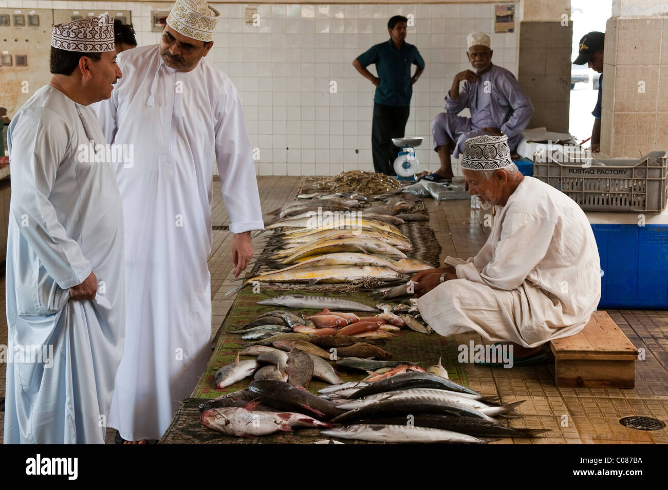 Two Omani men at a fish seller at the fish market in Muttrah, Oman ...