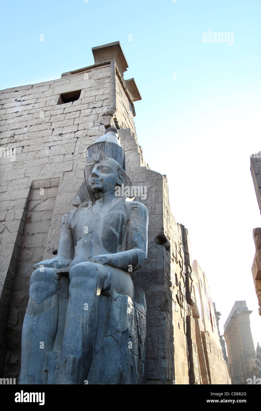 An ancient and historic big Egyptian statue stands guard at the ...