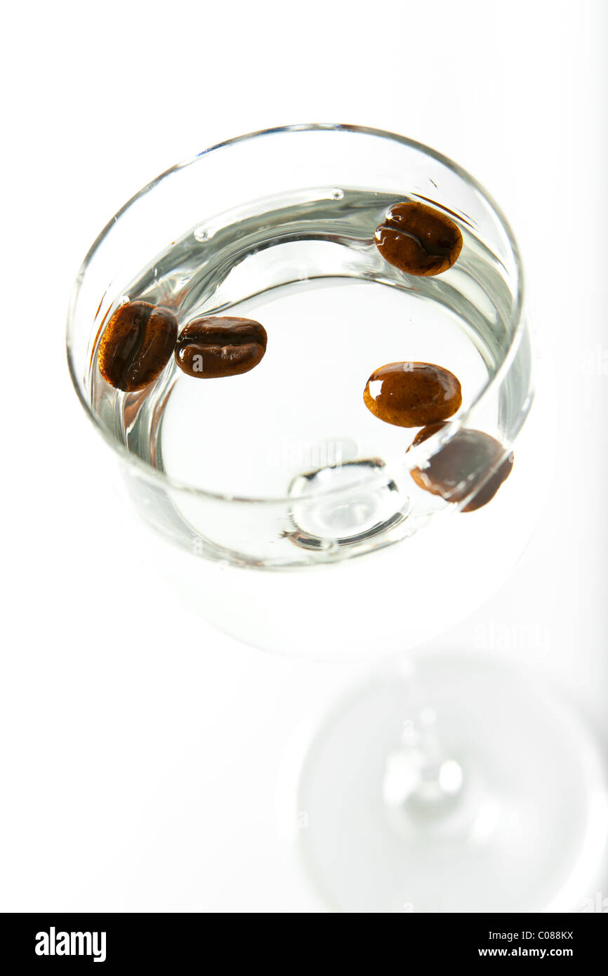 A glass of Sambuca with whole coffée beans a white background Stock ...
