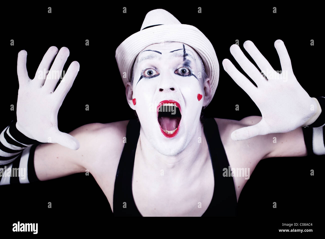 Funny screaming mime in white hat isolated on black background Stock ...