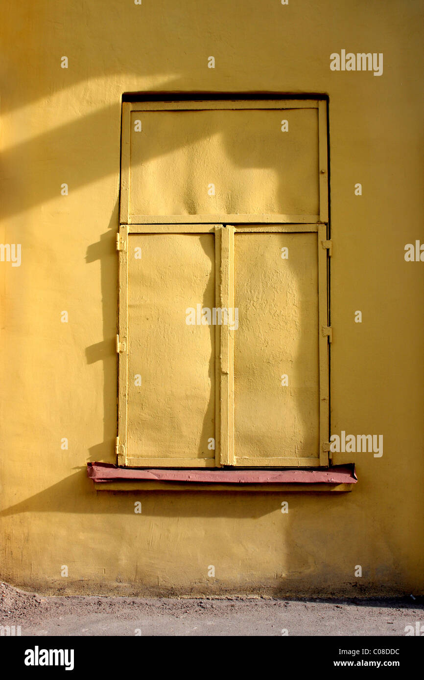 Yellow window on the yellow wall Stock Photo - Alamy