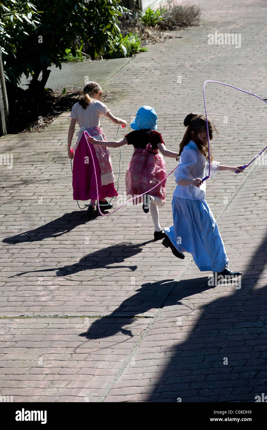Three girls playing in backyard Stock Photo - Alamy