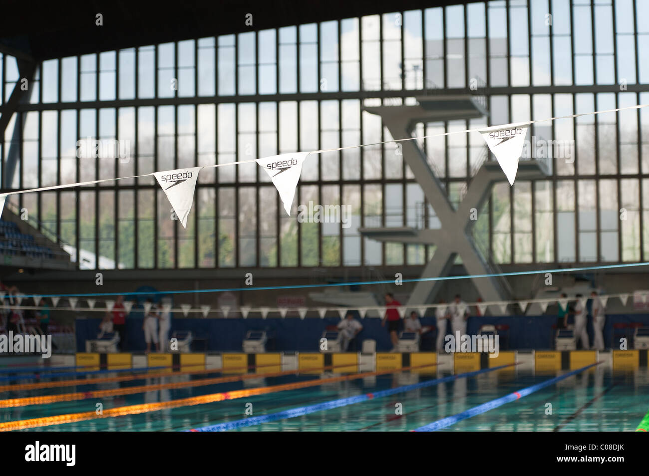 inside swimming pool competition with flags lane ropes diving platform ...