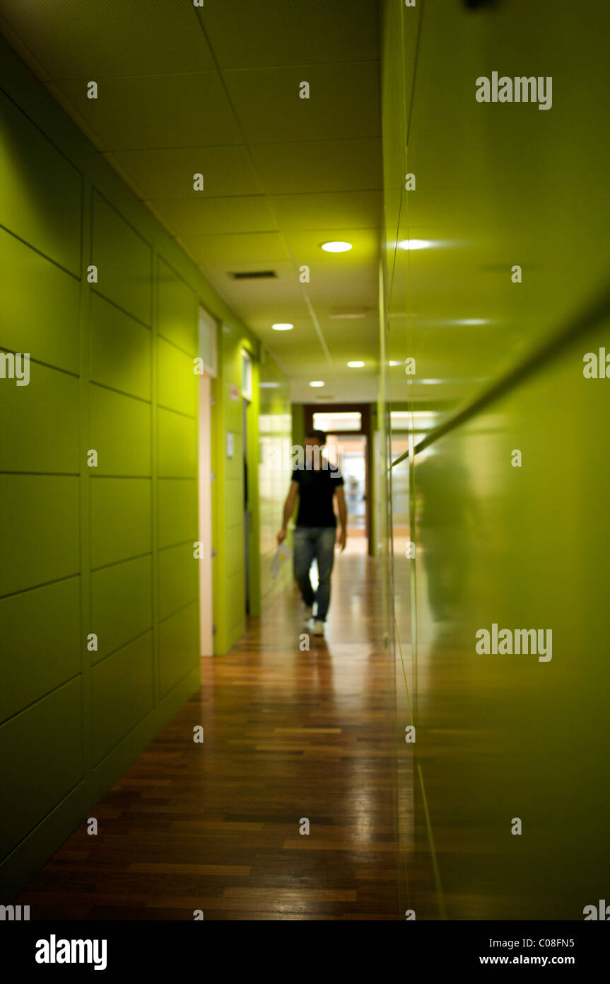 Man walking on a long hallway Stock Photo - Alamy