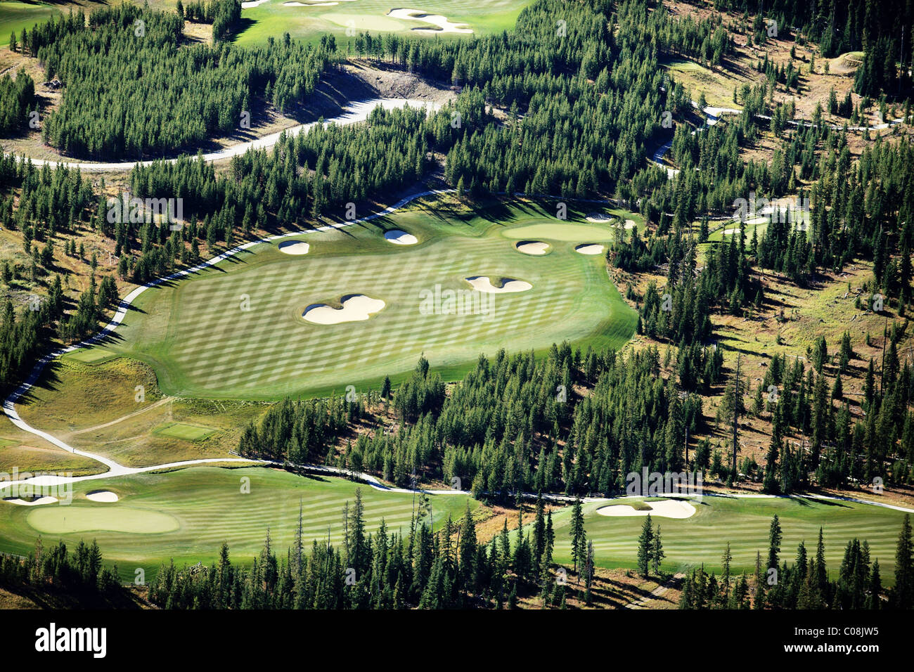 An aerial view of the fairway and green at a mountain resort golf ...