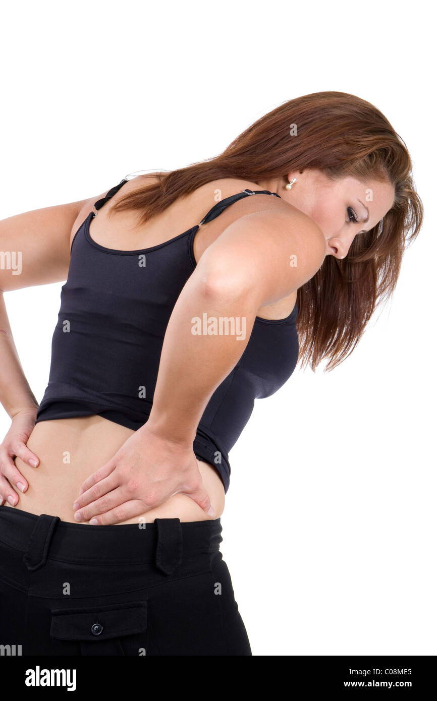 Woman bends over in pain rubbing her lower back as a result of a spinal ...