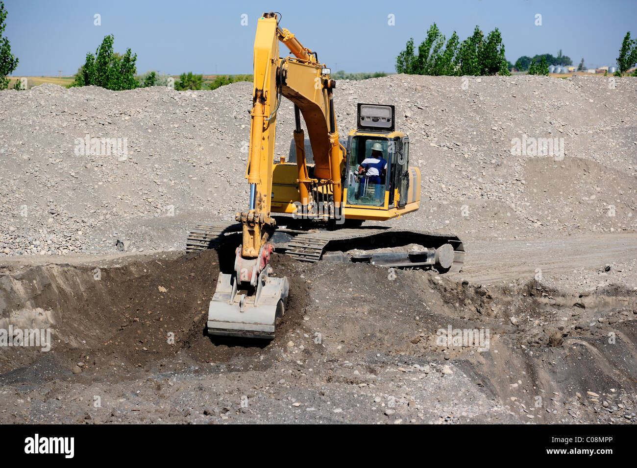 A large backhoe digging Stock Photo - Alamy