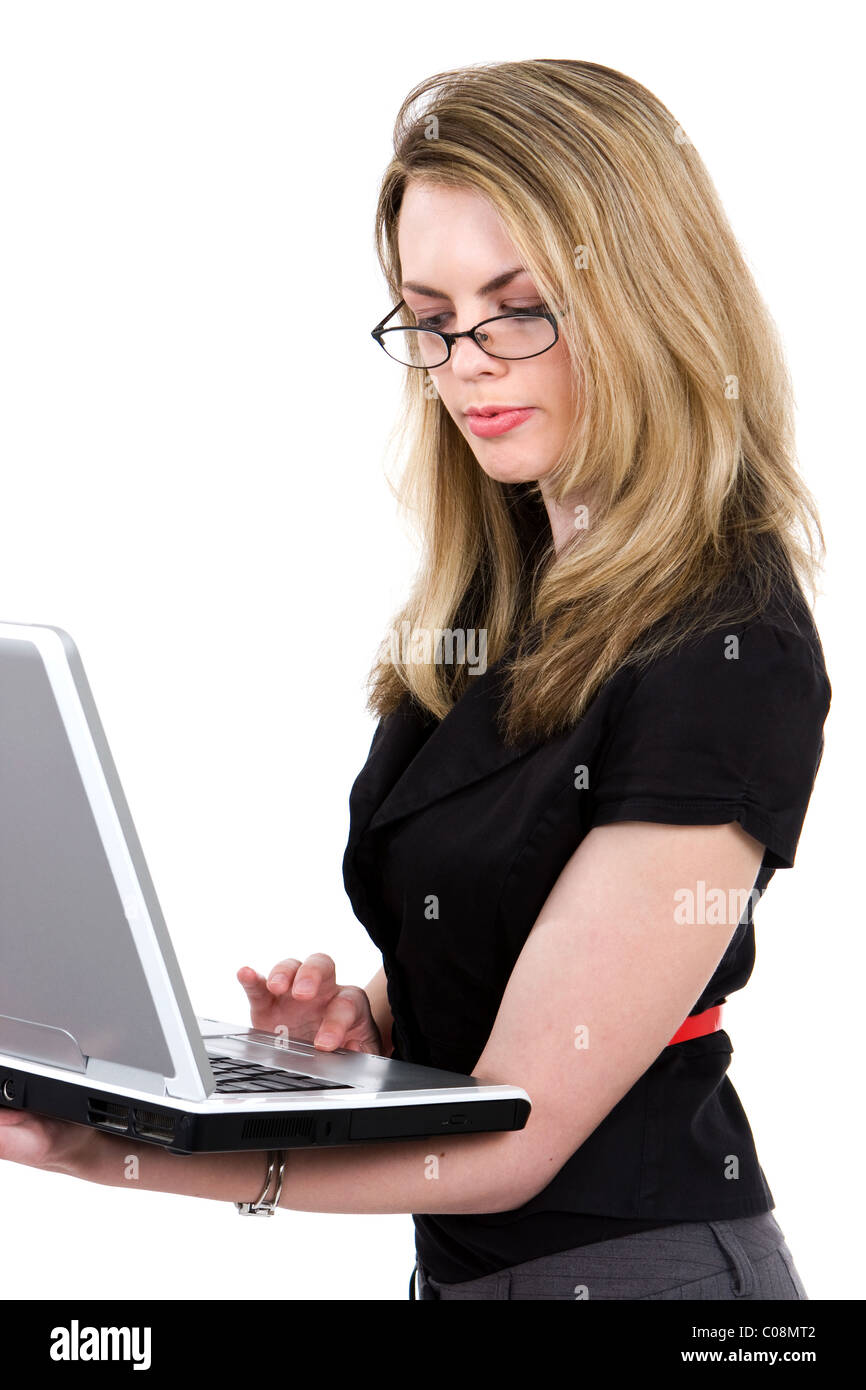 An attractive business woman uses a laptop computer as she works Stock ...