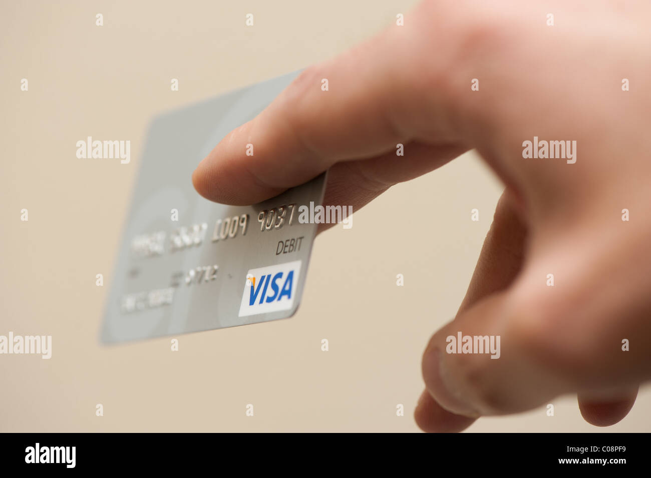 A hand paying with a Visa card Stock Photo - Alamy