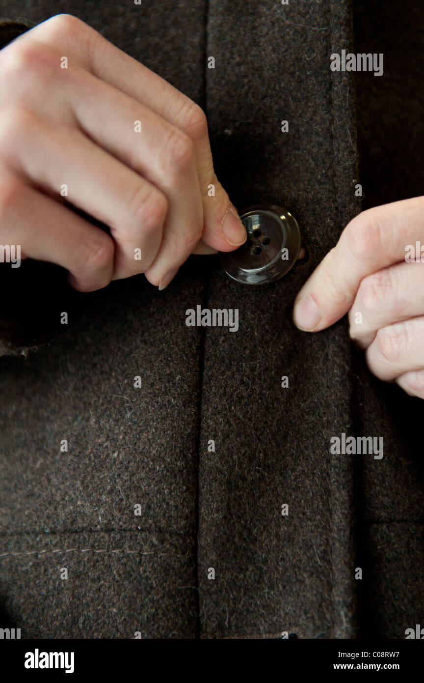 Hand zipping up jacket Stock Photo - Alamy