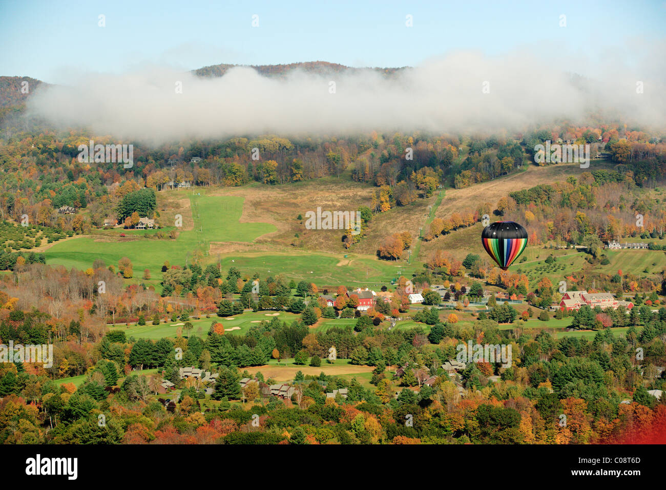 An aerial view of a hot air balloon floating over the Vermont country ...