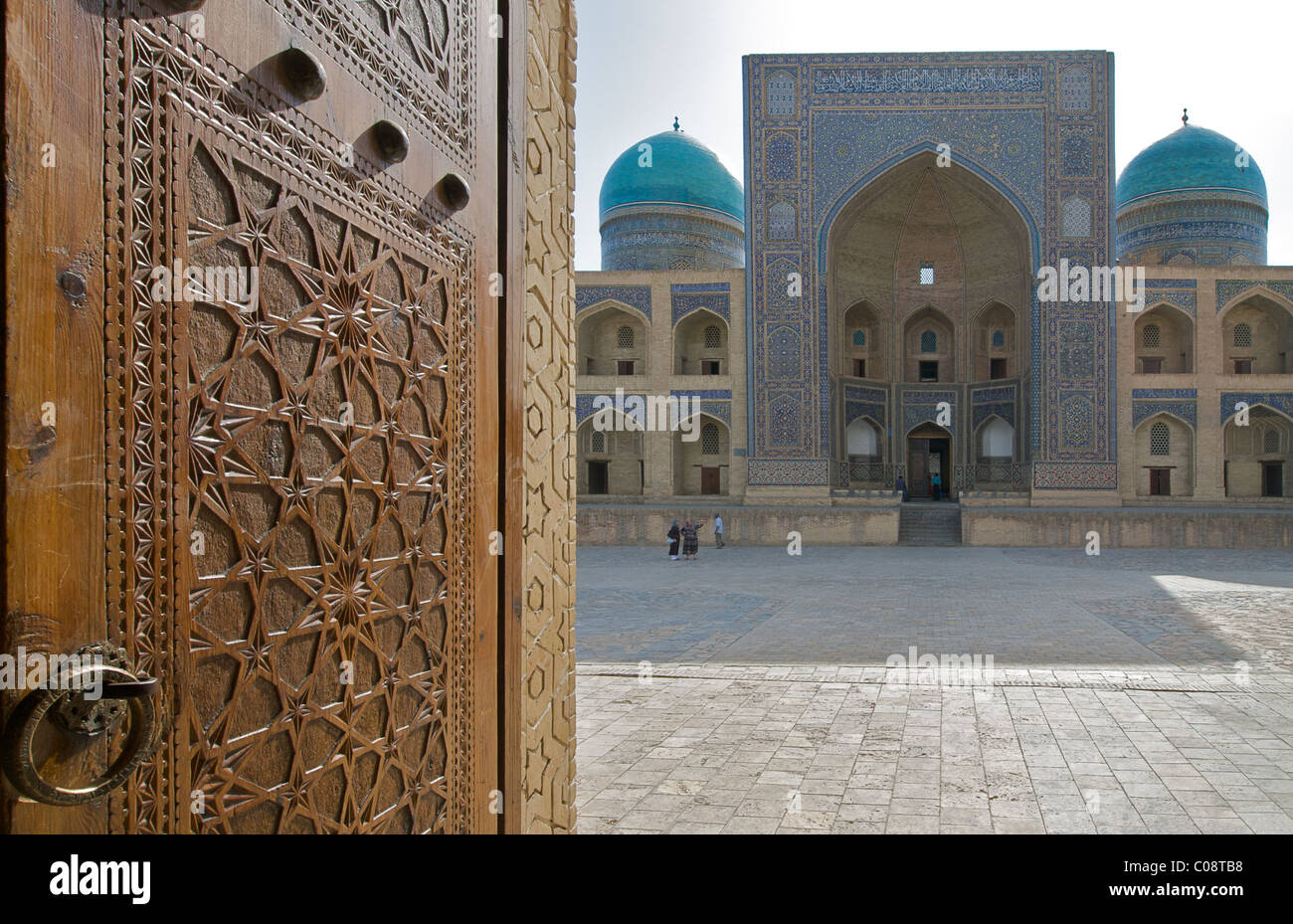 The Mir-i-arab Madrassah seen through the doors of the Kalon Mosque ...