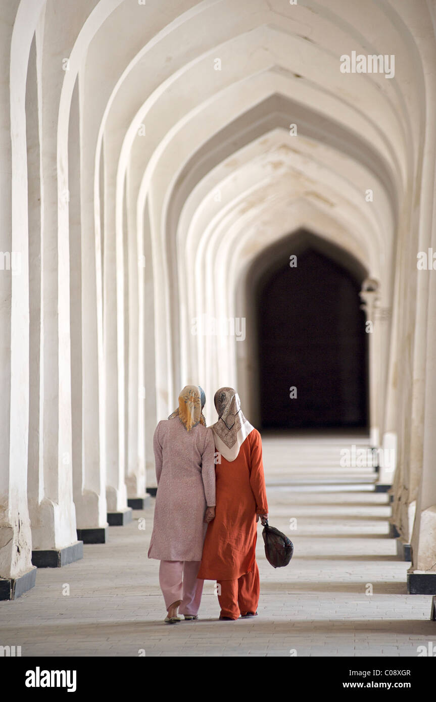 Uzbeki women walking down a vaulted corridor, Kalon Mosque, Bukhara ...