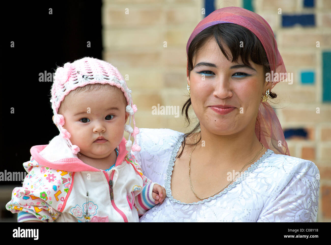 Portrait of an Uzbeki mother and child in the courtyard of the Kalon ...