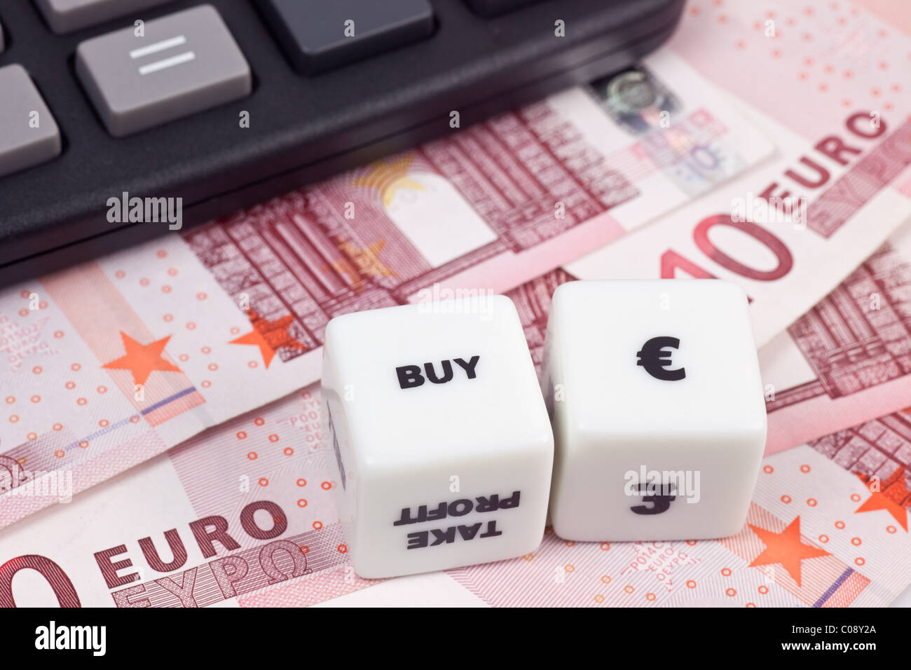 Euro currency with calculator and dice Stock Photo - Alamy