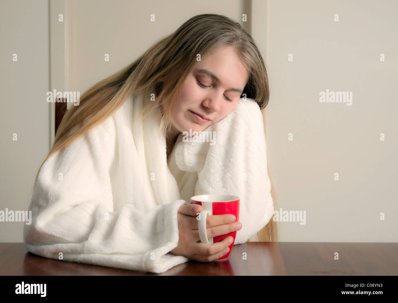 very tired young woman having coffee in the morning Stock Photo - Alamy