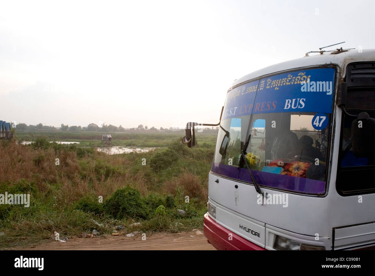 An express passenger bus is passing by a rural farming area on a ...