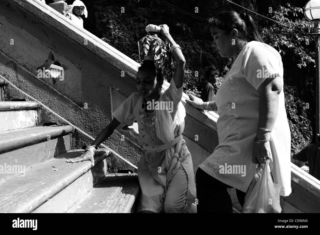 Woman devotee performing milk offering ritual during Thaipusam ...