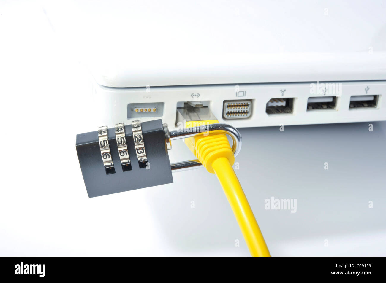 Network cable with a combination lock plugged into a notebook, symbolic ...