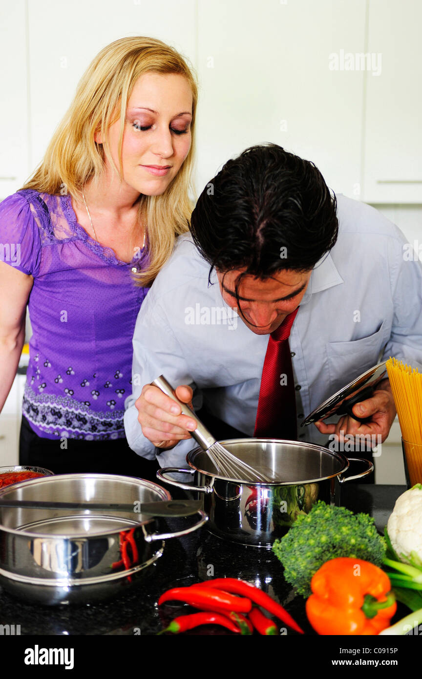 Young couple looking into a pot Stock Photo - Alamy