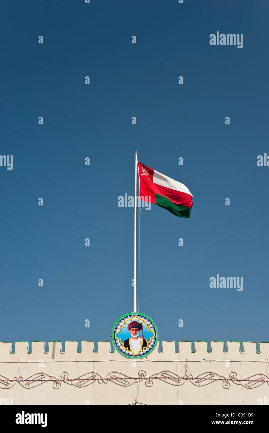 Omani flag above a portrait of Sultan Quaboos, Muscat, Oman, Middle ...