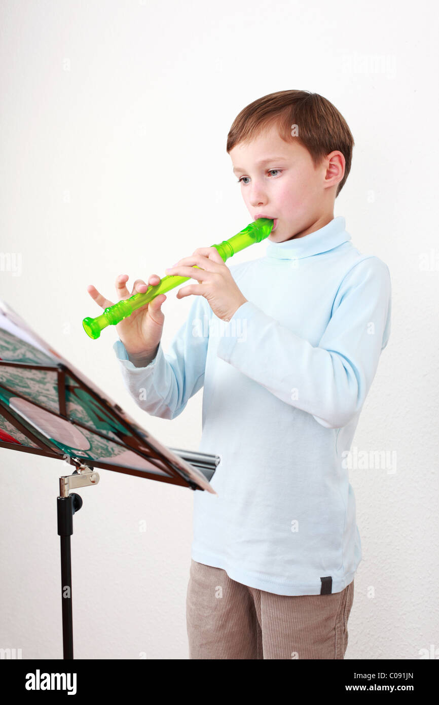 Smart little boy playing flute Stock Photo - Alamy