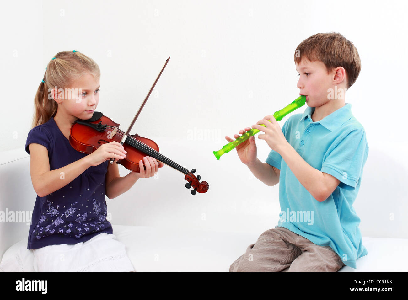 Cute kids playing flute and violin together Stock Photo - Alamy