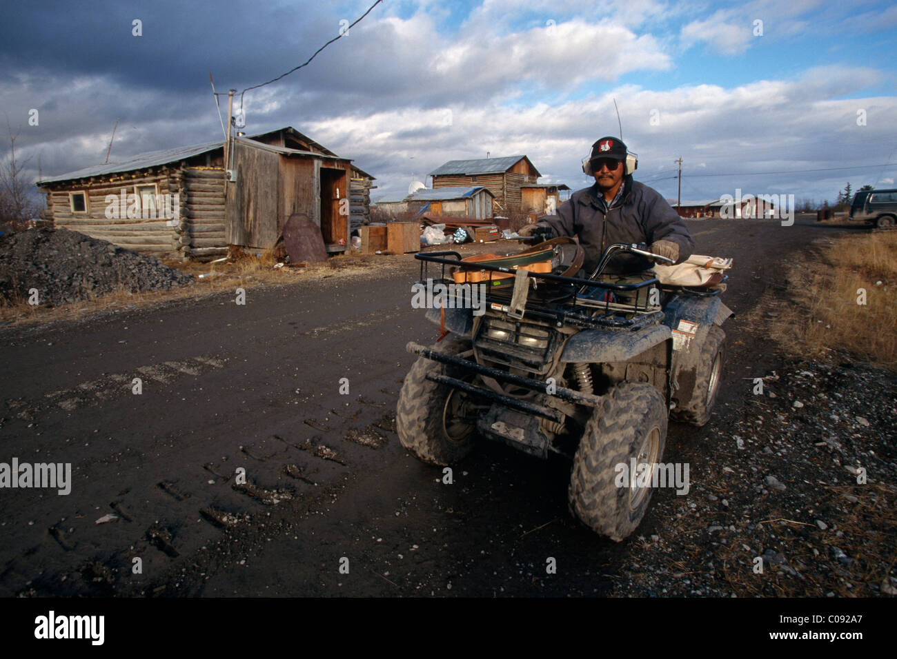 Native man rides an ATV on an Autumn day in Arctic Village, Arctic ...