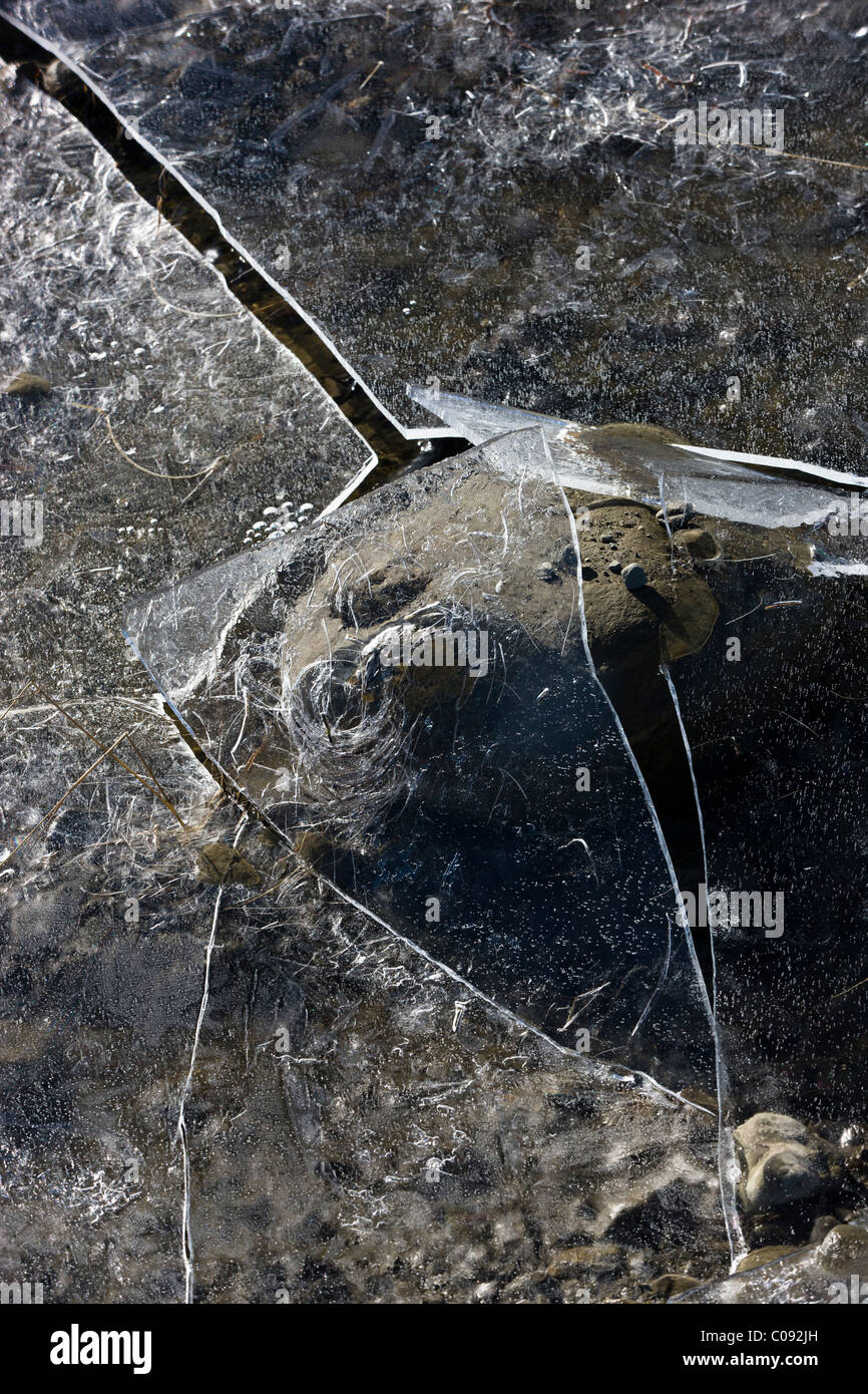 Close up detail of ice patterns in a frozen meltwater pond caused by a ...
