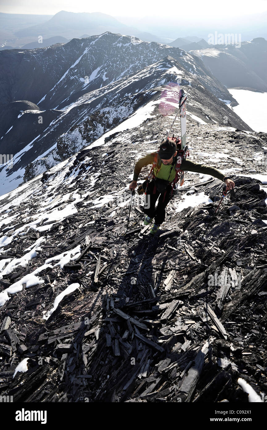 Backcountry skier makes an early morning ascent of the north side of Mt ...