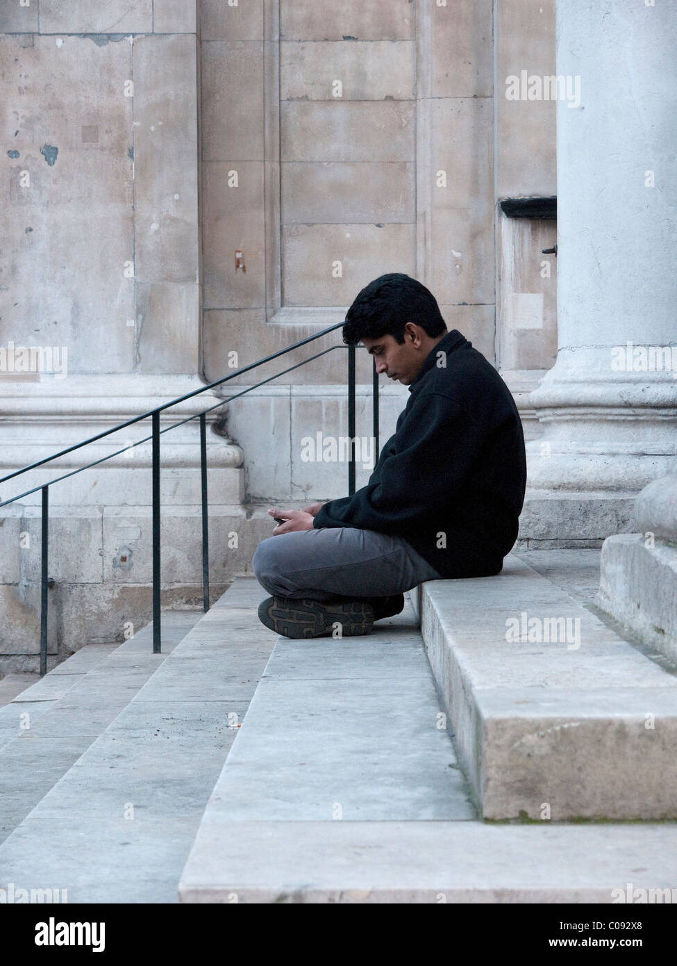 man sending text step steps sit sitting stair Stock Photo - Alamy