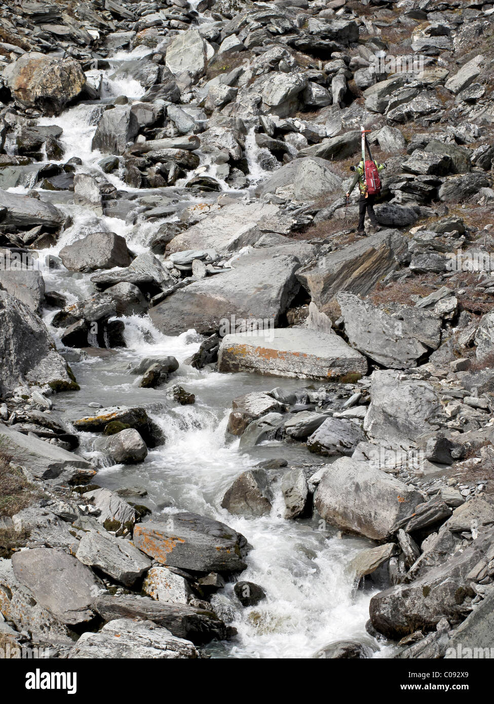Backpacker next to a creek in the Katak Creek valley hiking to Mt ...