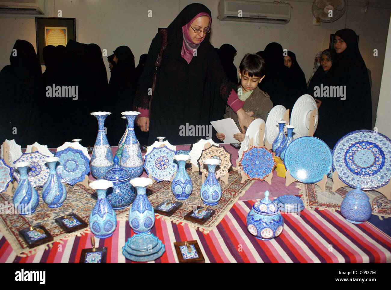 Women take keen at stalls during art exhibition of Iranian Artist Mehdi ...