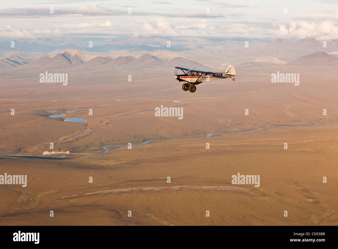 Aerial view of a Piper Super Cub airplane flying over the Jago River ...