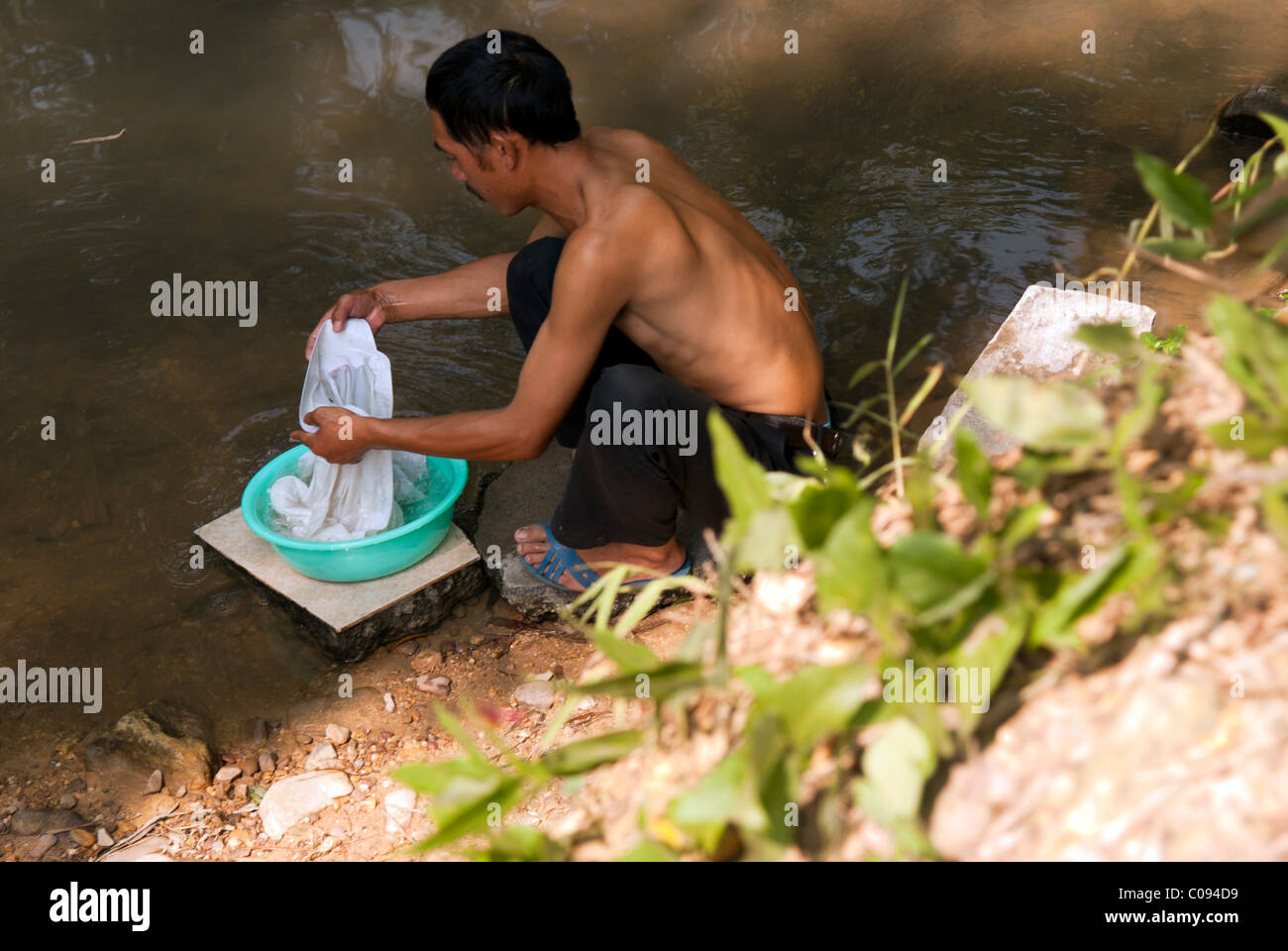 Chinese man washing clothes in hi-res stock photography and images - Alamy
