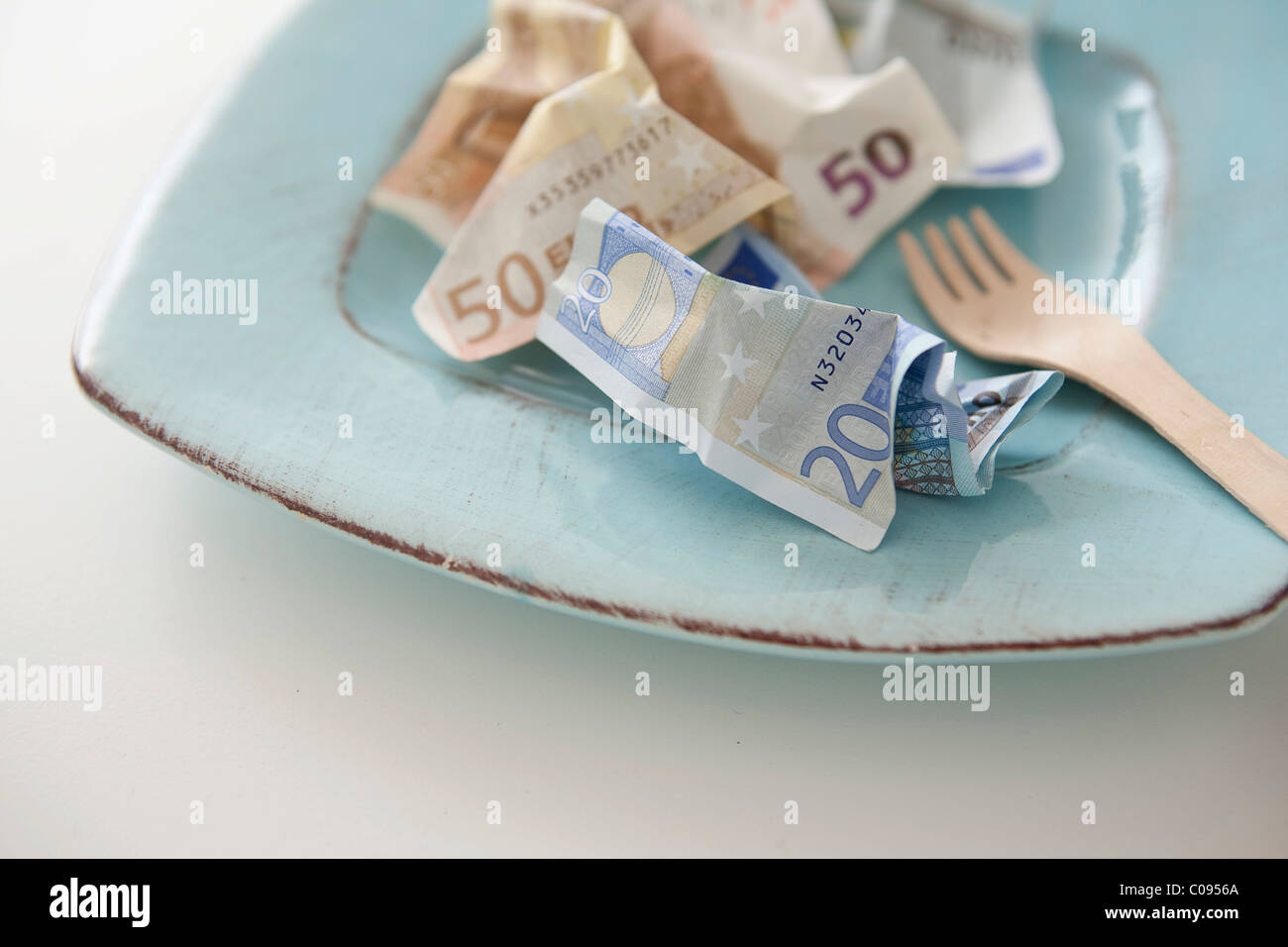 Bank notes on a plate, symbolic image Stock Photo - Alamy