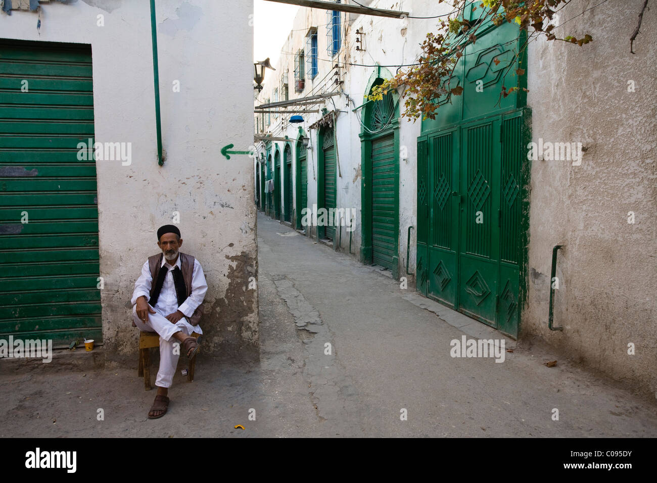 Old man sitting in an alley of the Medina, historic centre, Tripoli ...