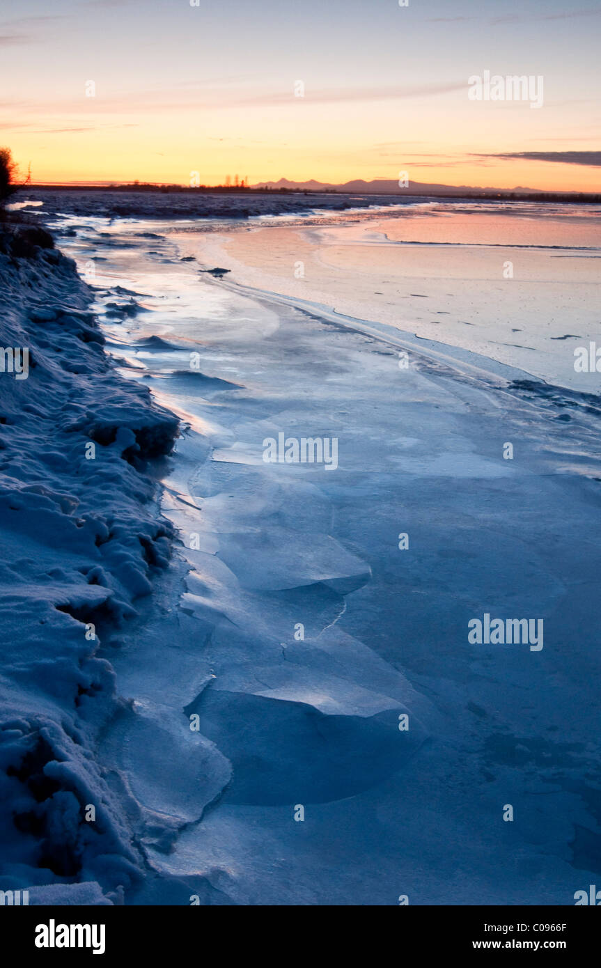View of frozen ice along the Knik River at sunset, Southcentral Alaska ...