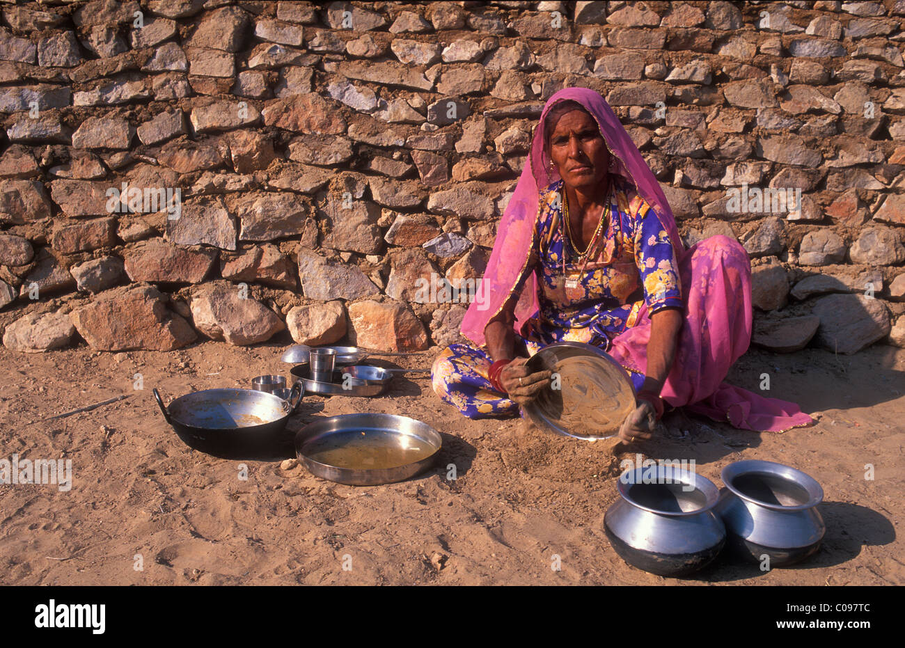 Woman cleaning dishes with sand, Thar Desert, Rajasthan, India, Asia ...