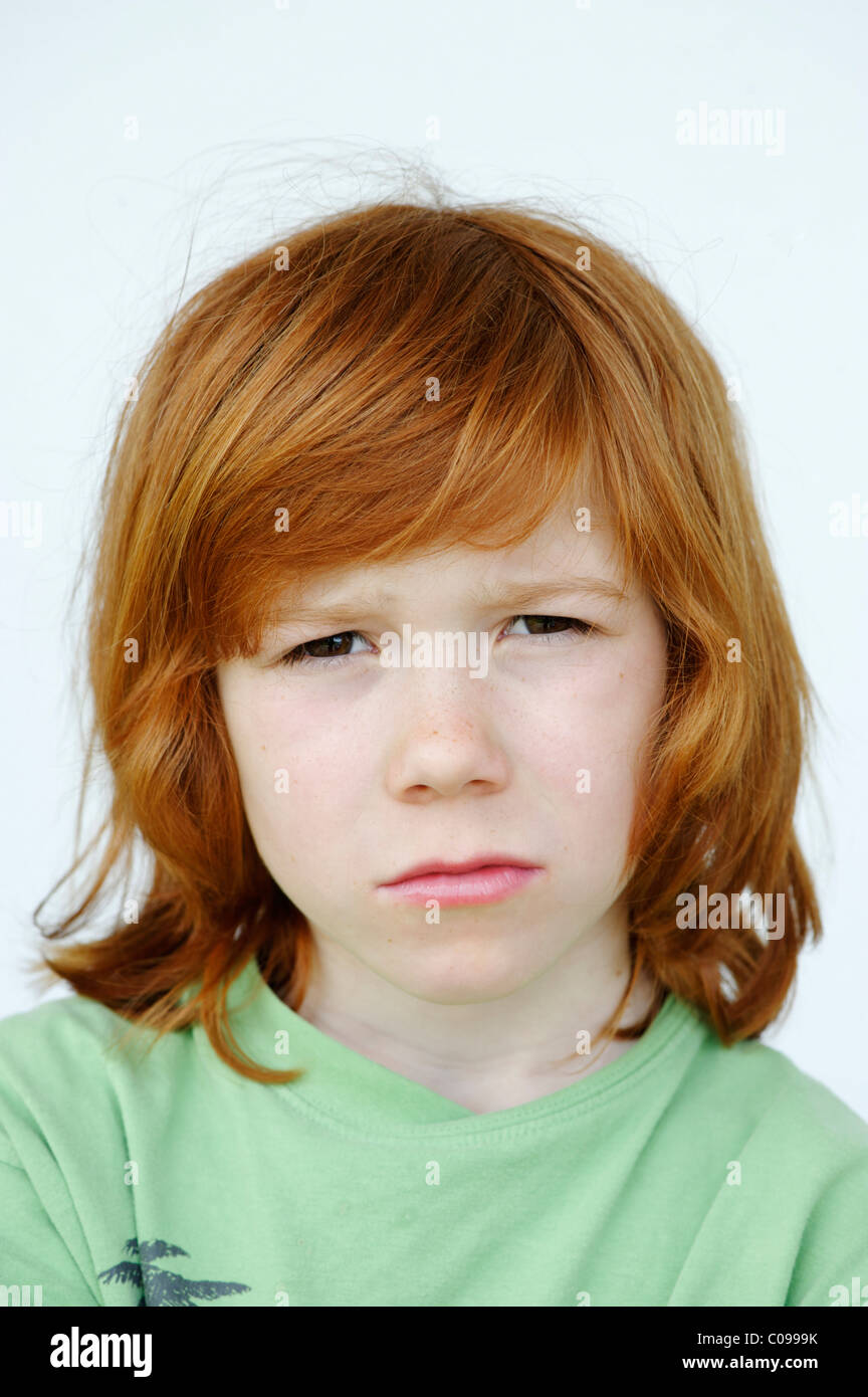 Boy, 10, with long hair, looking sad, sulking, unhappy Stock Photo - Alamy