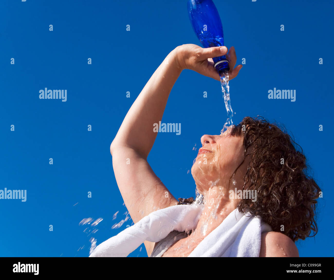 Woman pouring water over her head as a refreshment Stock Photo - Alamy
