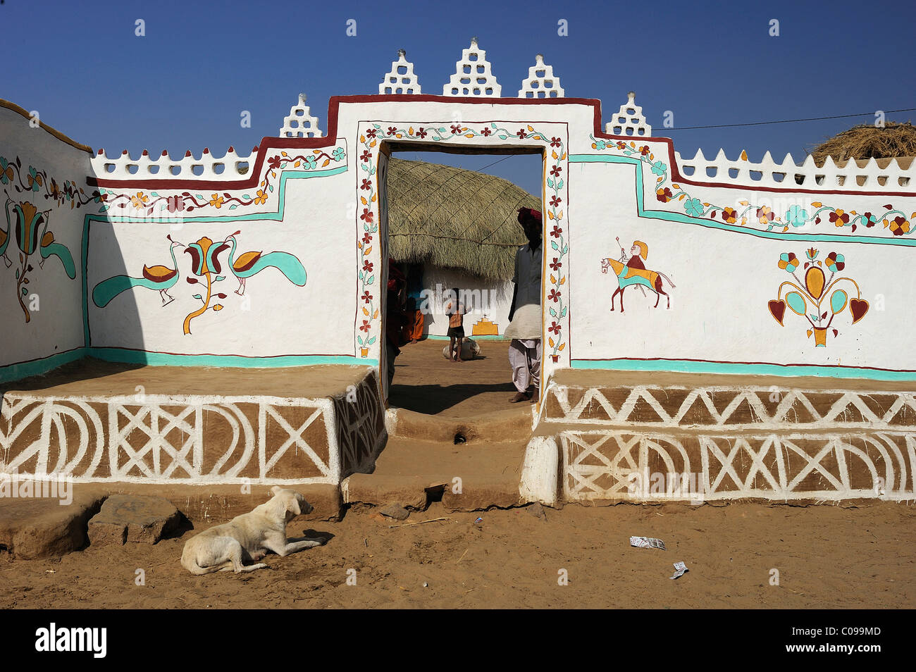 Traditionally painted wall and entrance to the courtyard of a house ...