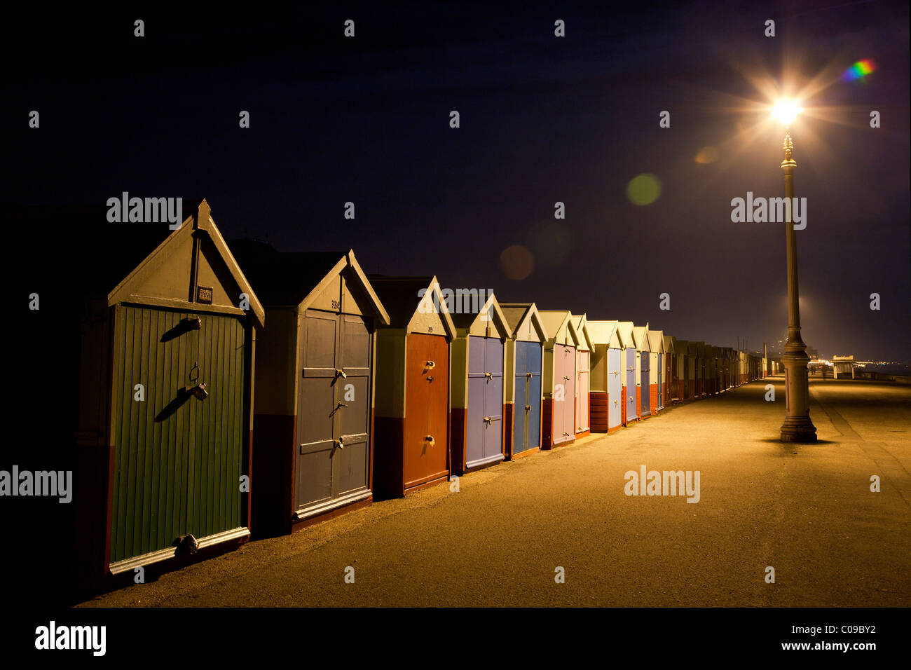 Brighton beach huts at night with street light illumination Stock Photo ...